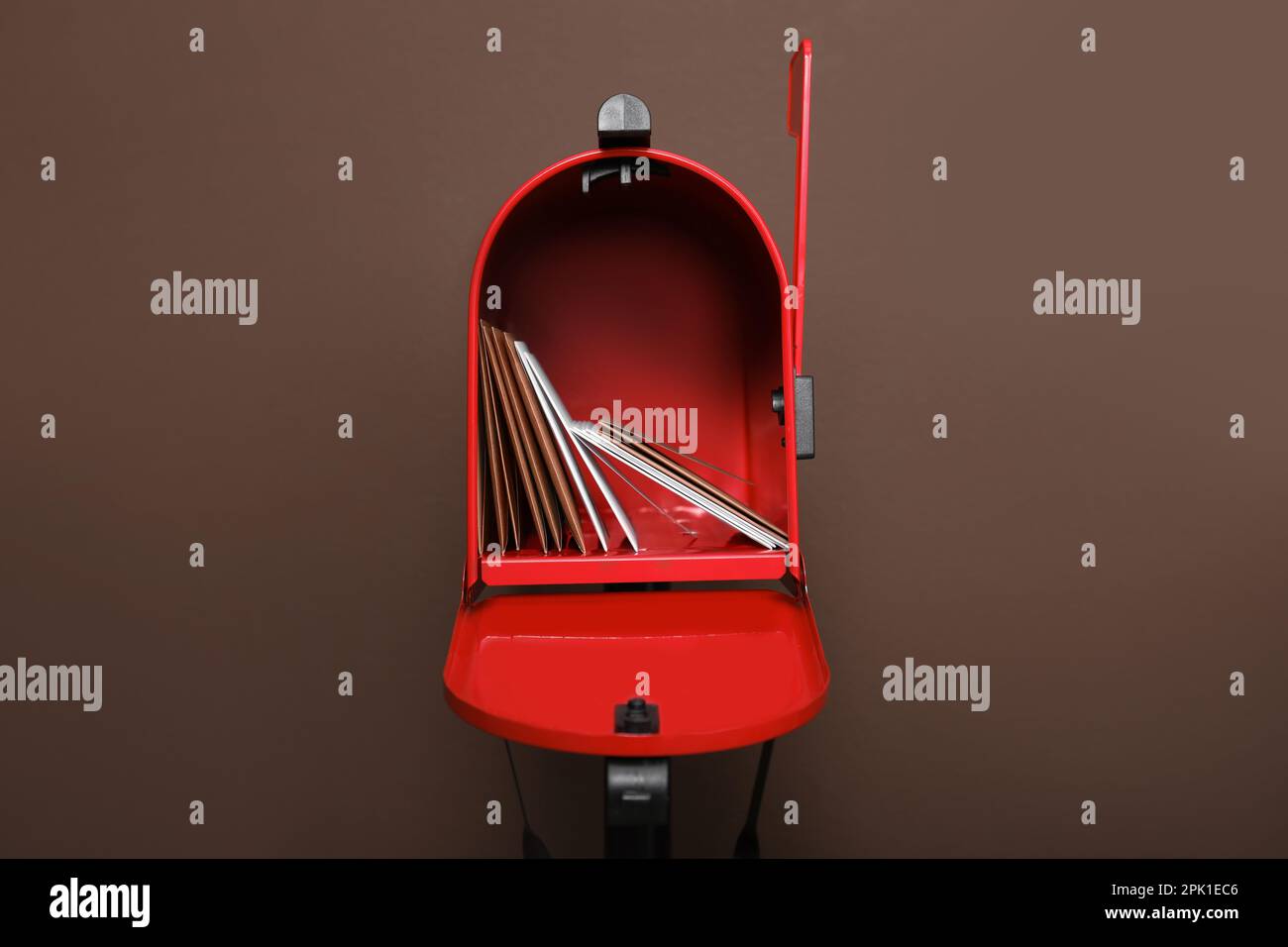 Open red letter box with envelopes against brown background Stock Photo ...
