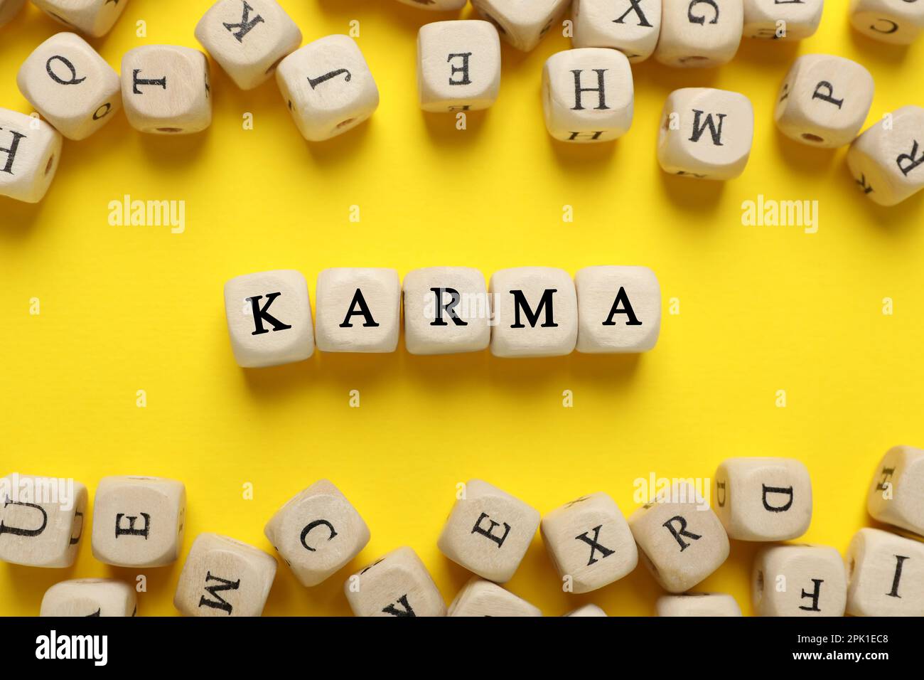 Word Karma made of cubes with letters on yellow background, flat lay ...