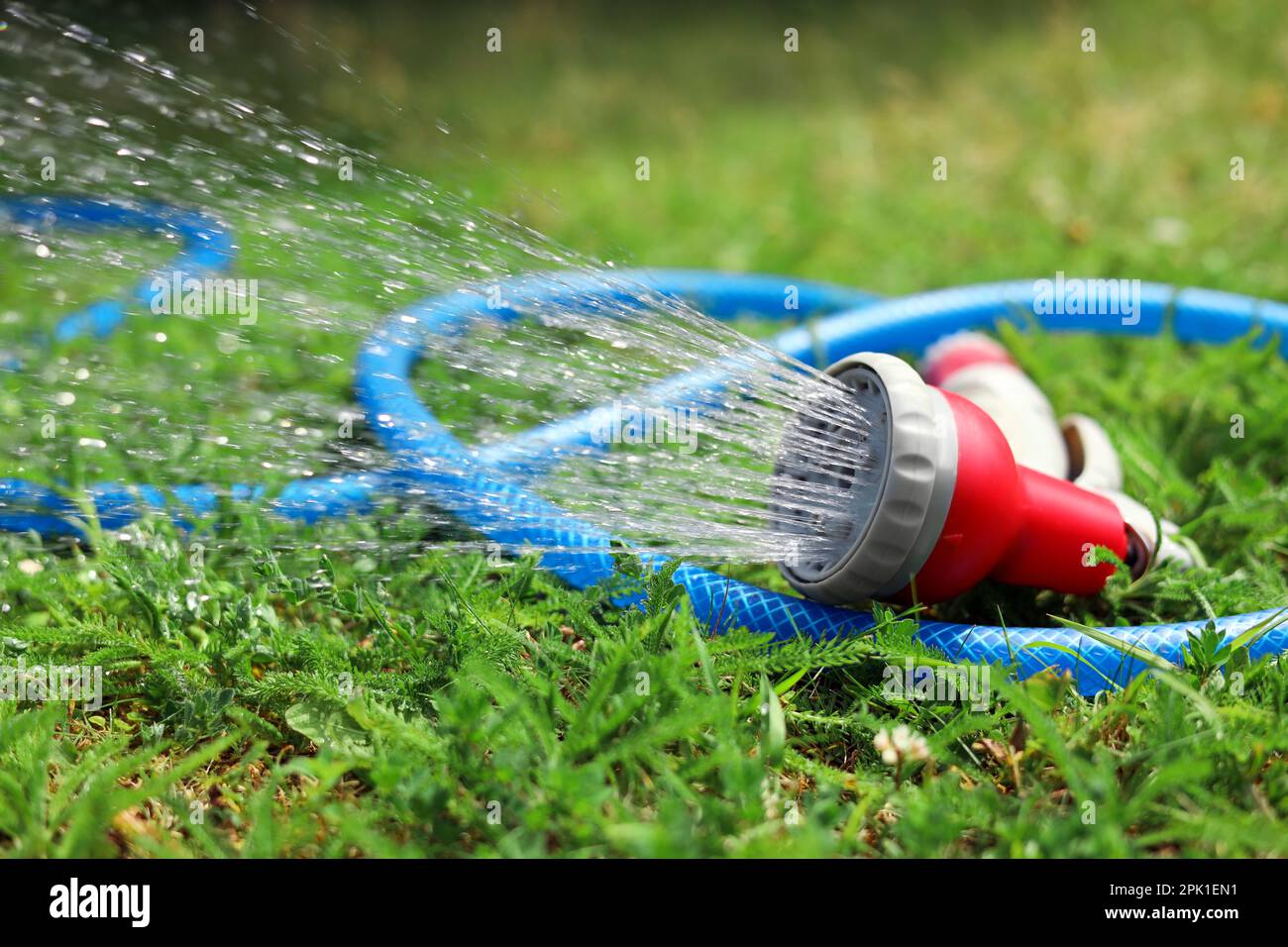 Water spraying from hosepipe sprinkler hi-res stock photography and ...