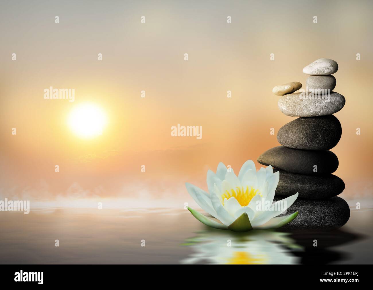 Zen, meditation, harmony. Beautiful lotus flower and stack of stones on ...
