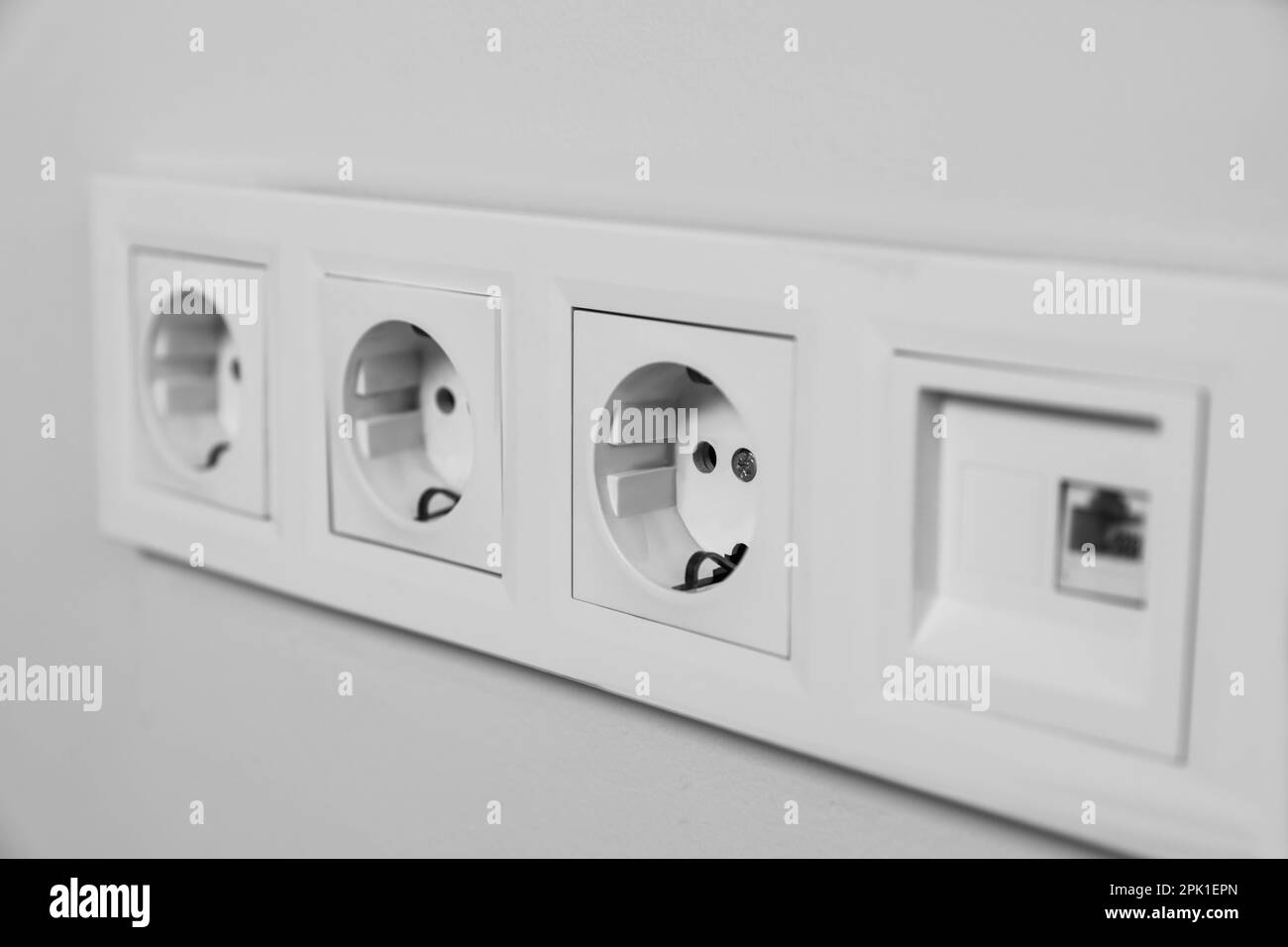 Power sockets on white wall, closeup. Electrical supply Stock Photo - Alamy