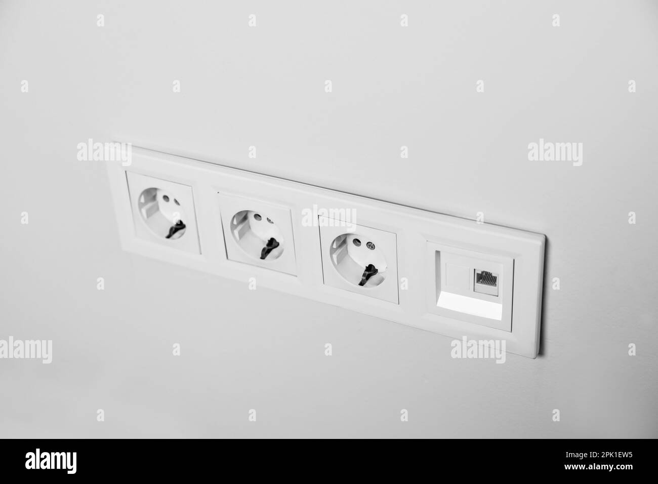 Power sockets on white wall, closeup. Electrical supply Stock Photo - Alamy
