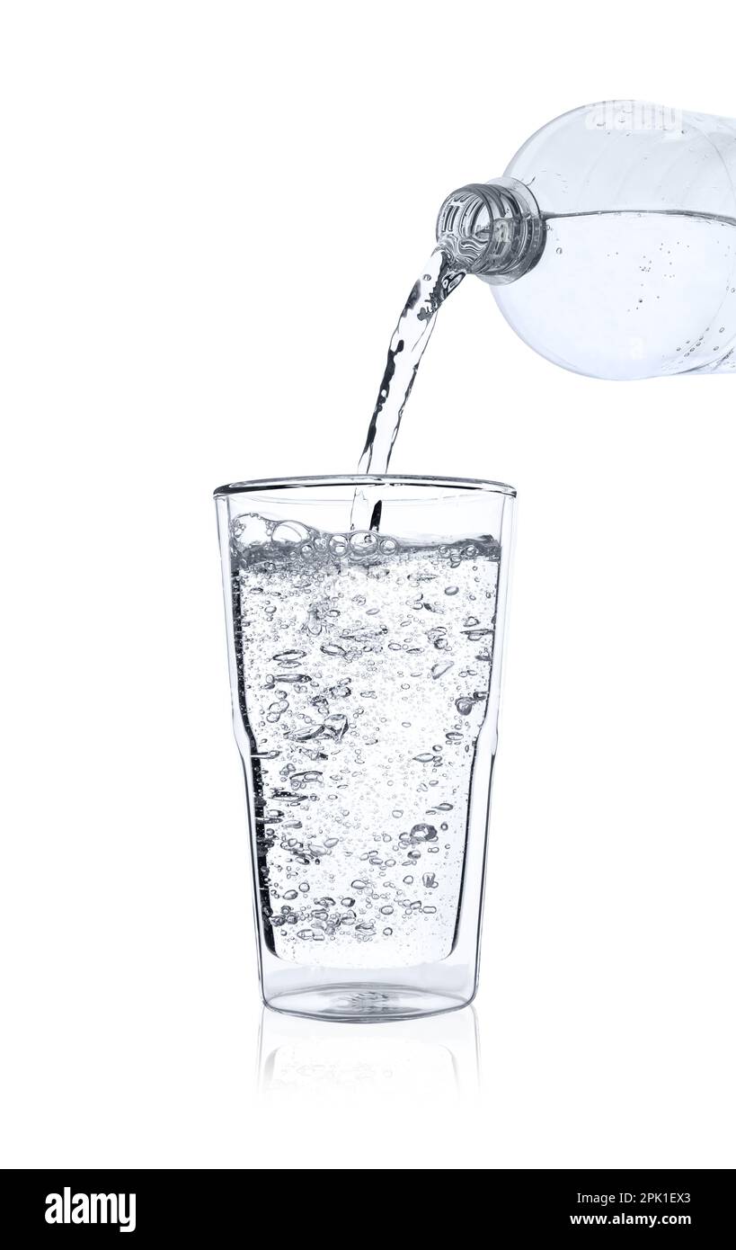 Pouring soda water from bottle into glass on white background Stock ...