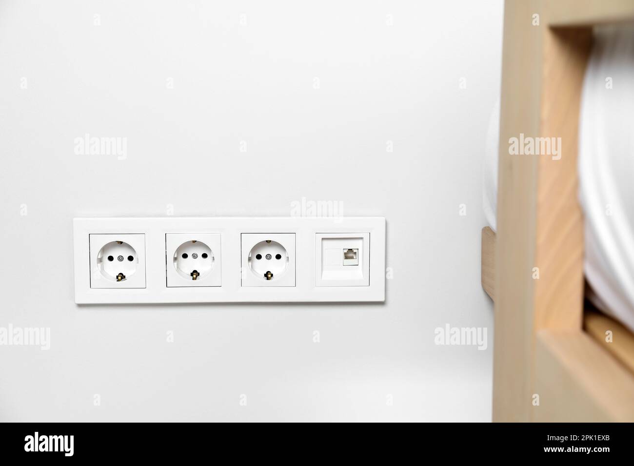 Power sockets on white wall indoors. Electrical supply Stock Photo - Alamy