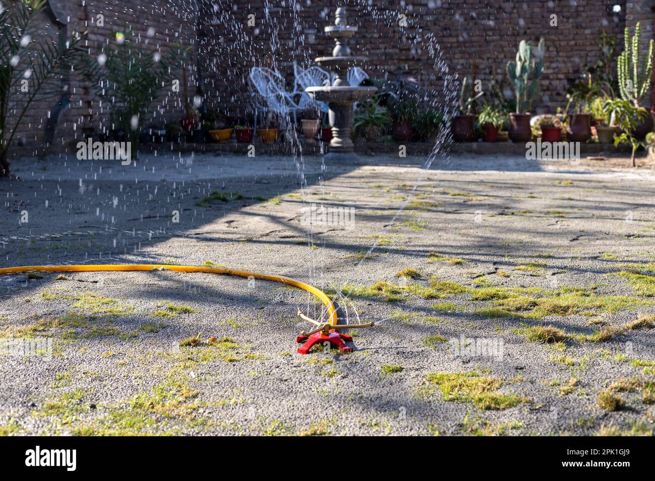 Watering the lawn with a 360 degree rotation sprinkler water system ...