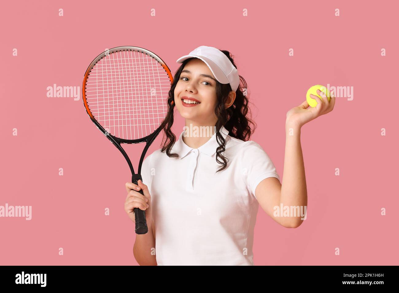 Teenage tennis player with racket and ball on pink background Stock ...