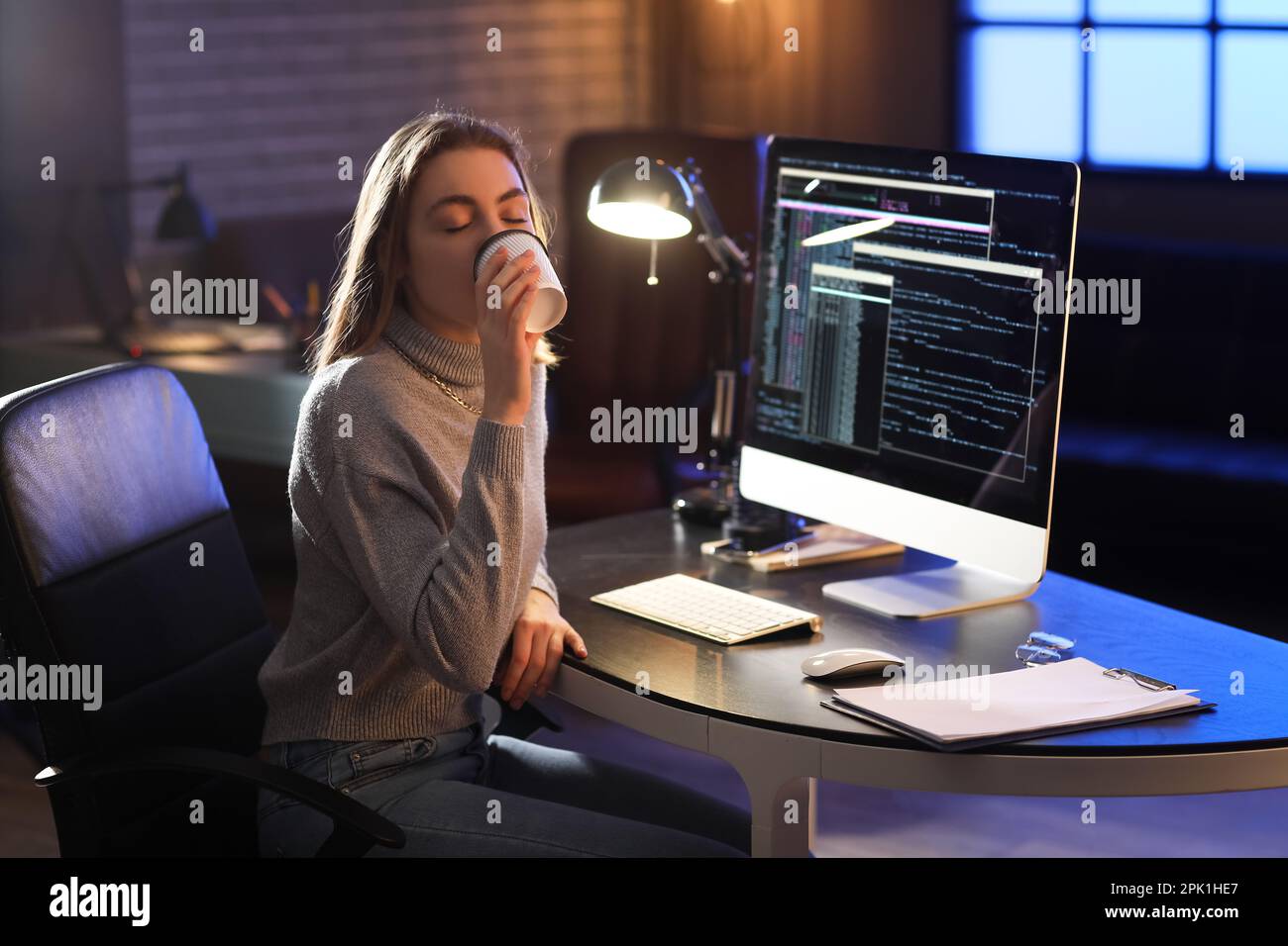 Female programmer drinking coffee in office at night Stock Photo - Alamy Female programmer drinking coffee in office at night Stock Photo - Alamy