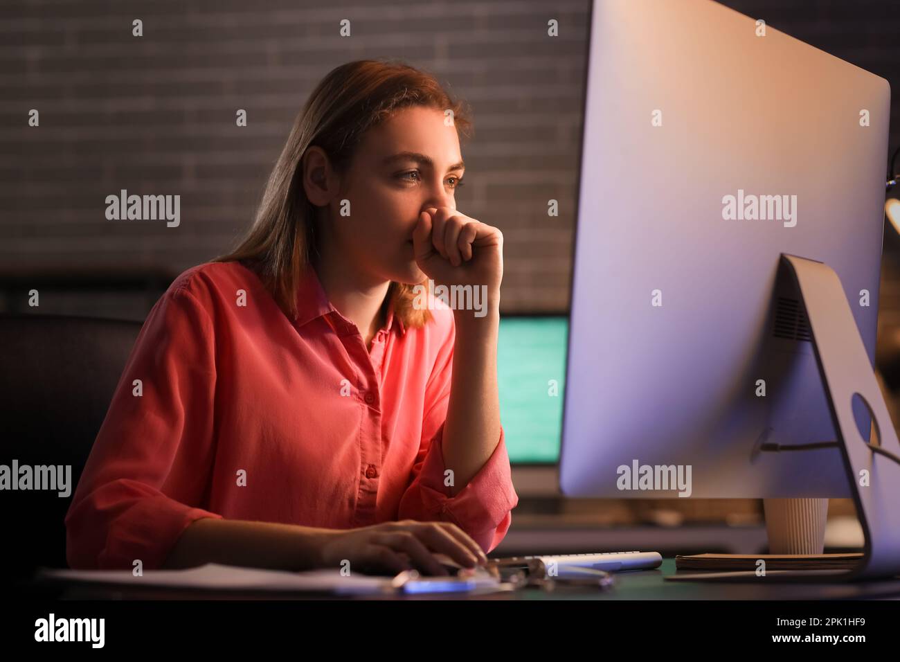Female programmer working with computer in office at night Stock Photo ...