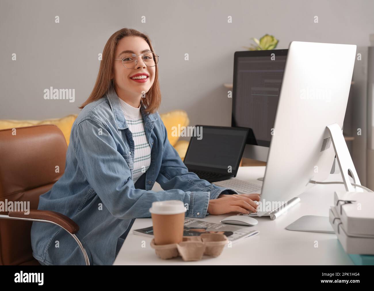 Female programmer working with computer at table in office Stock Photo ...