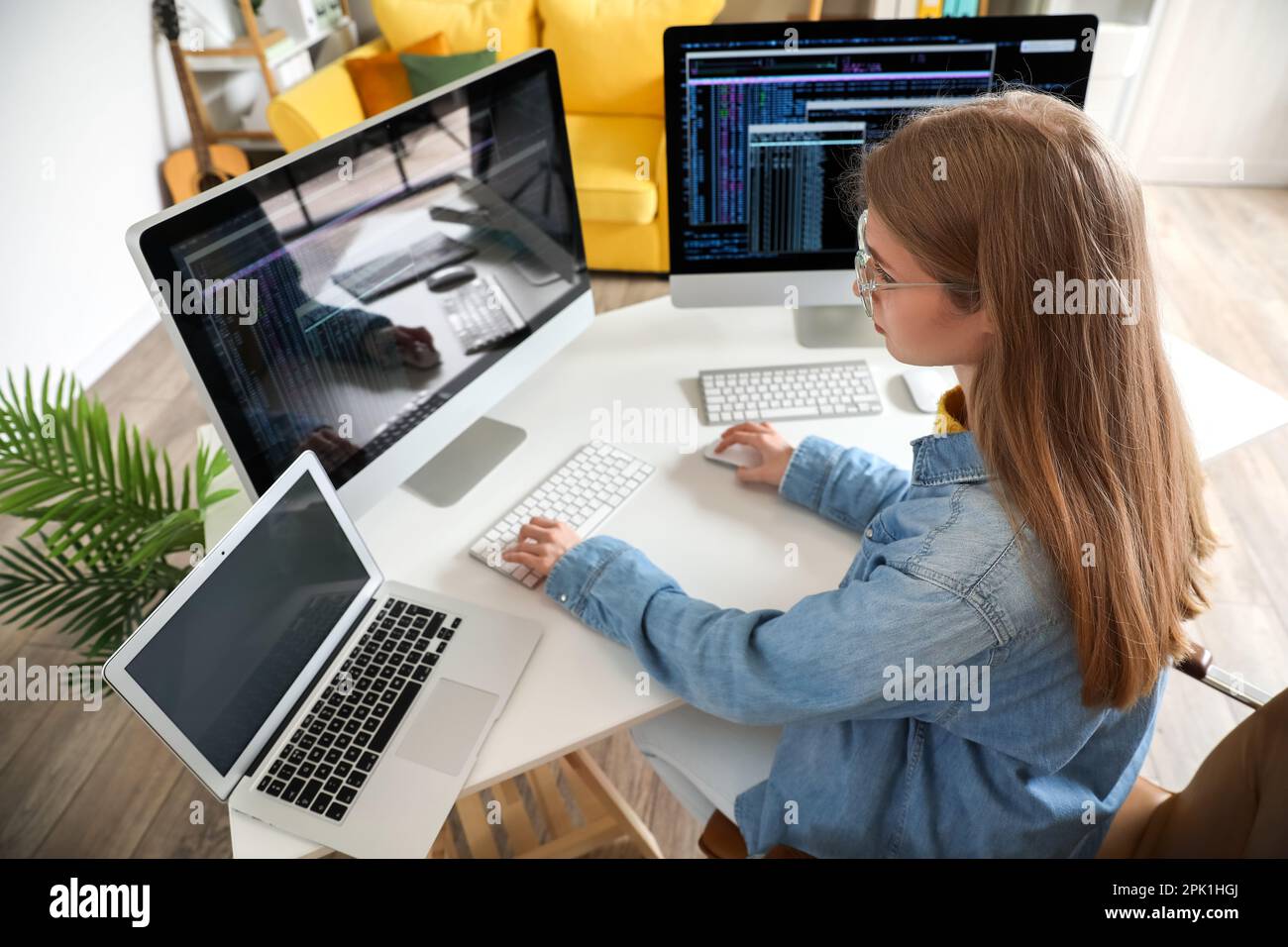 Female programmer working with computer at table in office Stock Photo ...
