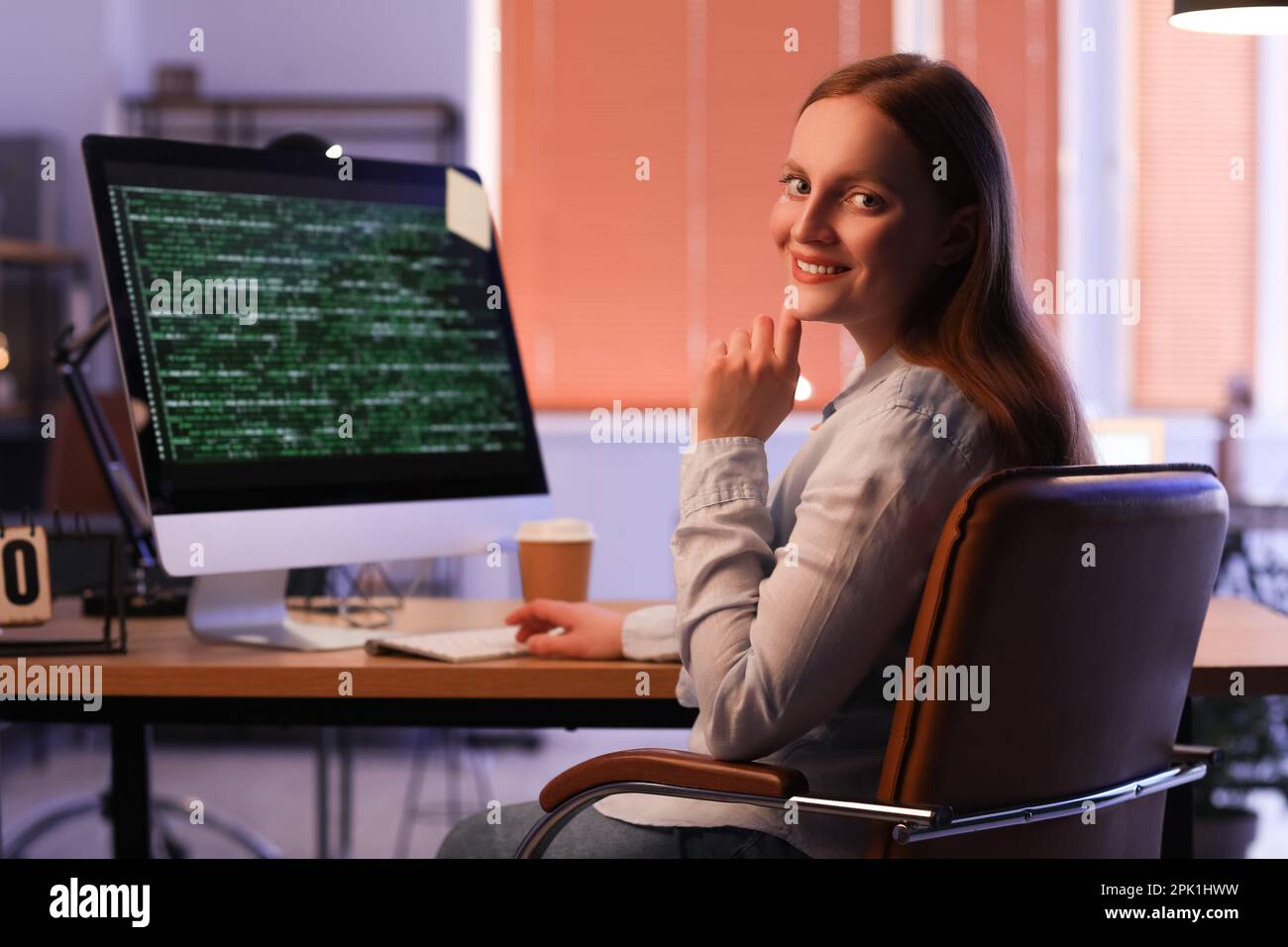 Female programmer working with computer in office at night Stock Photo ...