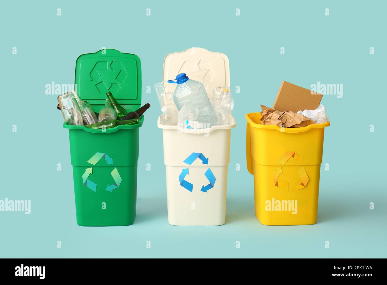 Containers with different types of garbage on light blue background ...