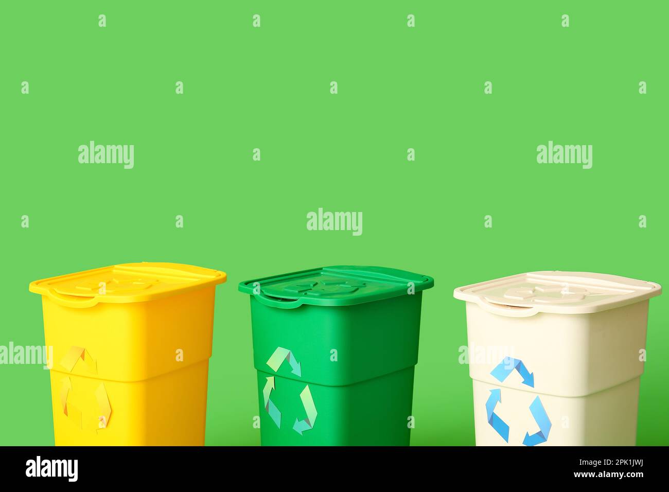 Containers for garbage on green background. Recycling concept Stock ...