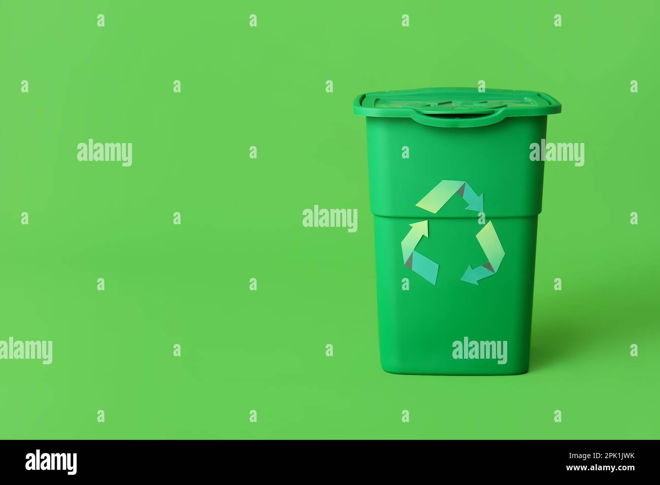 Container for garbage on green background. Recycling concept Stock ...
