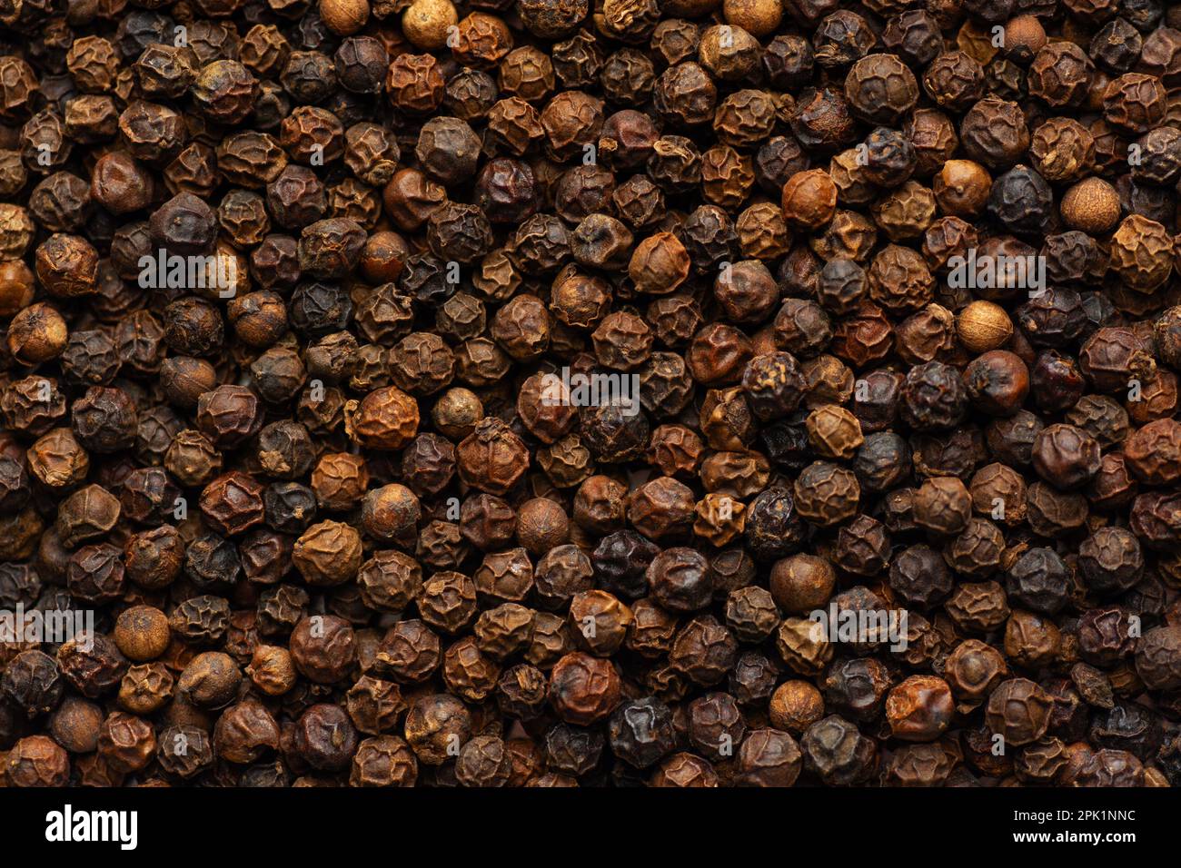 Black pepper grains as background close up Stock Photo - Alamy