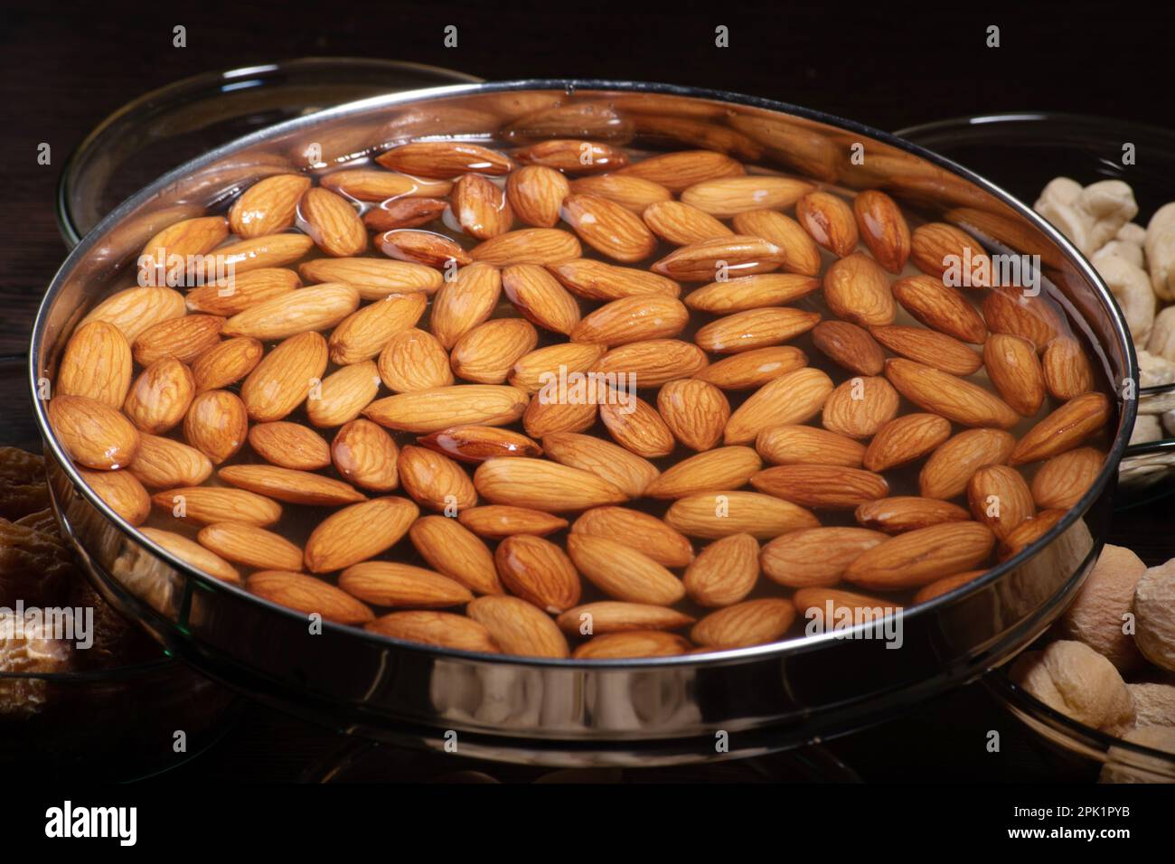 Soaked almond in water bowl, healthy food Stock Photo - Alamy