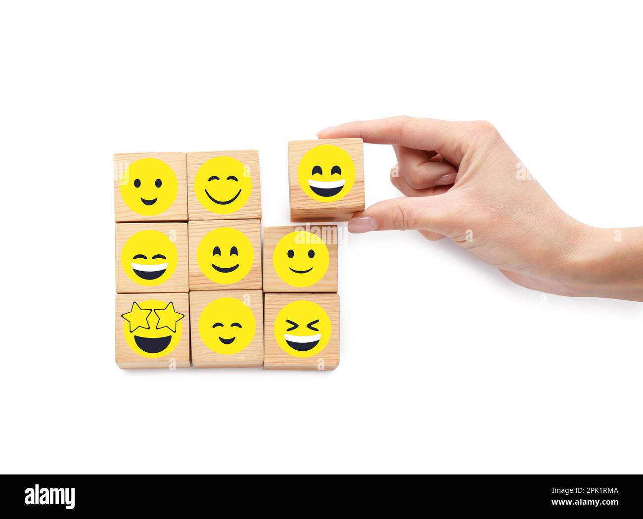 Woman holding cube with smiling face among other with emoticons on ...