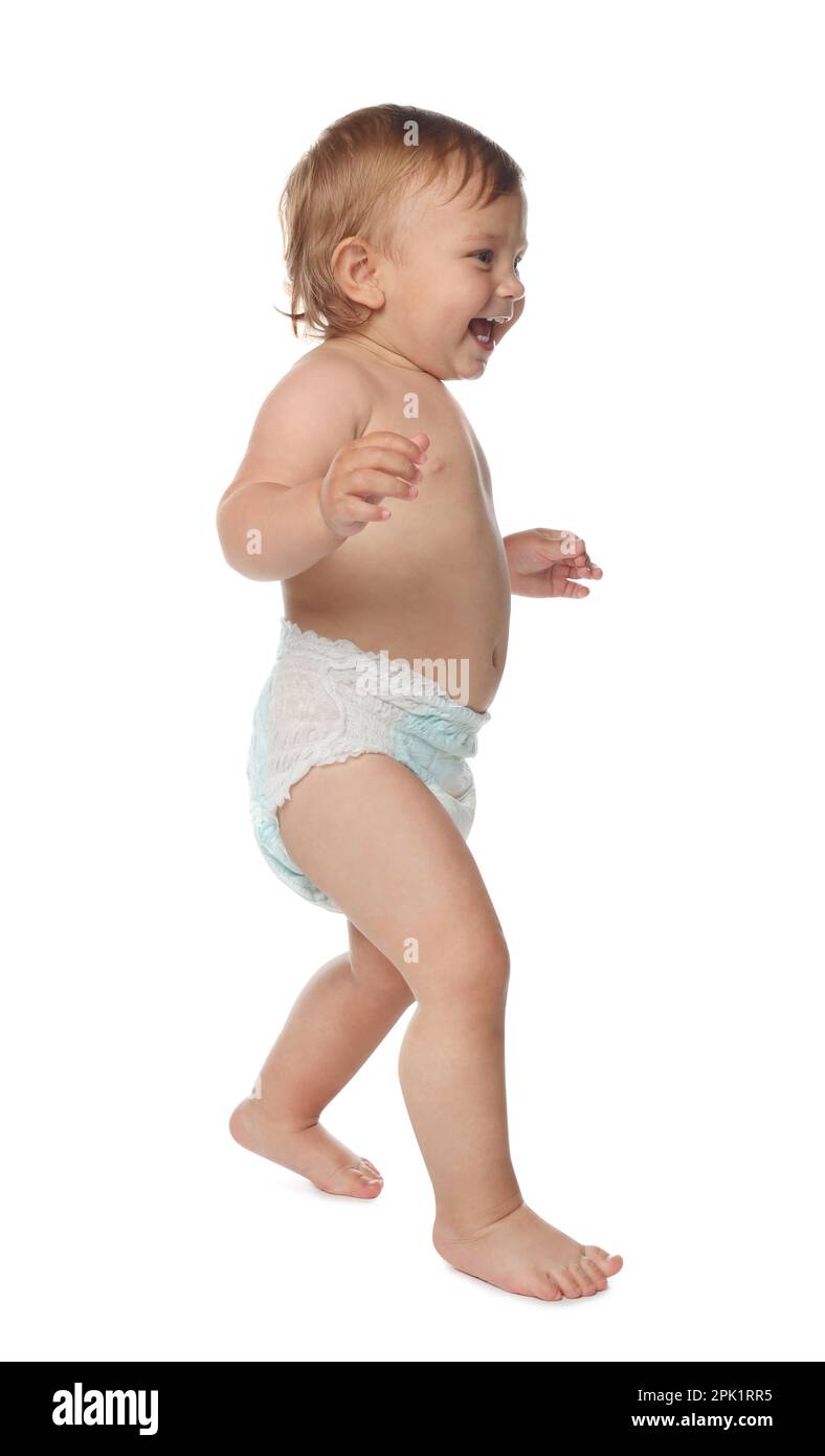 Cute baby in diaper learning to walk on white background Stock Photo ...
