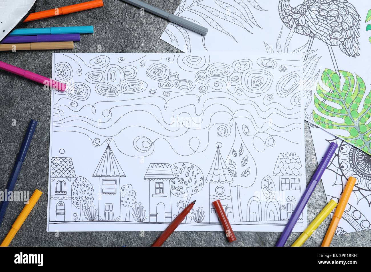 Antistress coloring pages and felt tip pens on grey table, flat lay ...