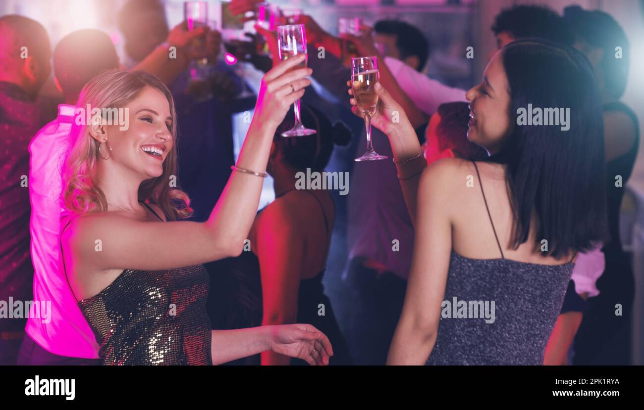 Theyre playing our song. two young women toasting with their drinks ...