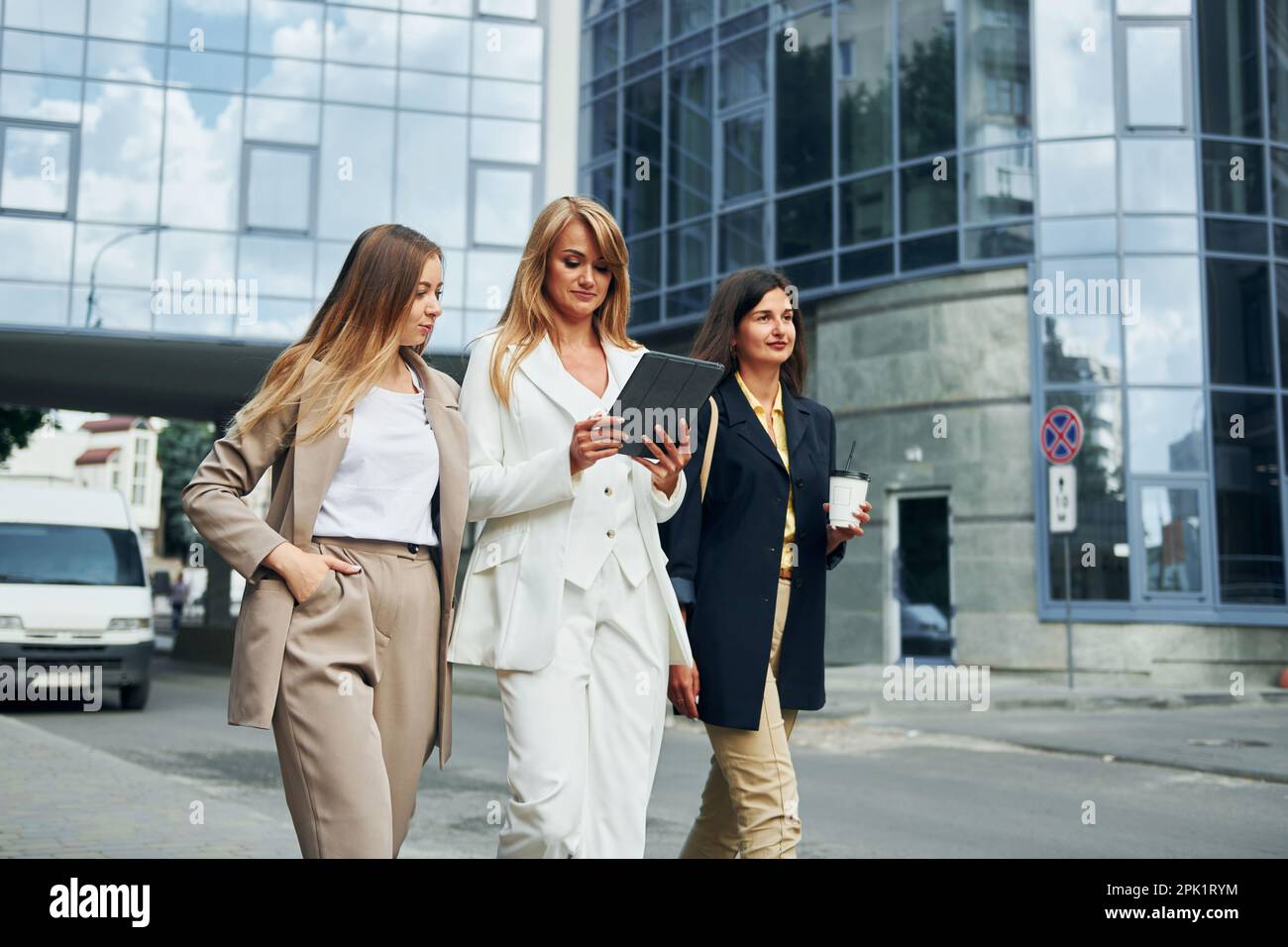 Positive women in formal wear is outdoors in the city together Stock ...