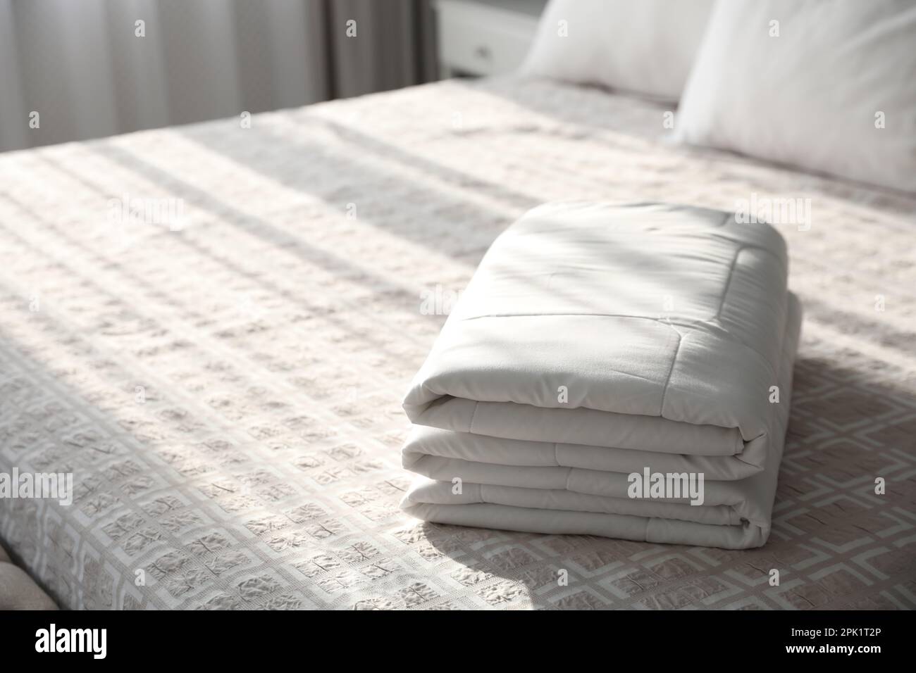 Folded clean blanket on bed in room. Space for text Stock Photo - Alamy