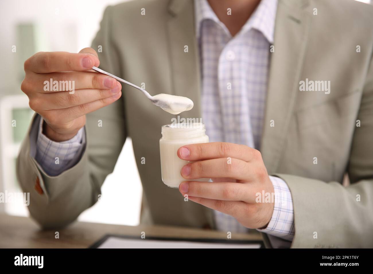 Man eating yogurt sitting table hi-res stock photography and images - Alamy