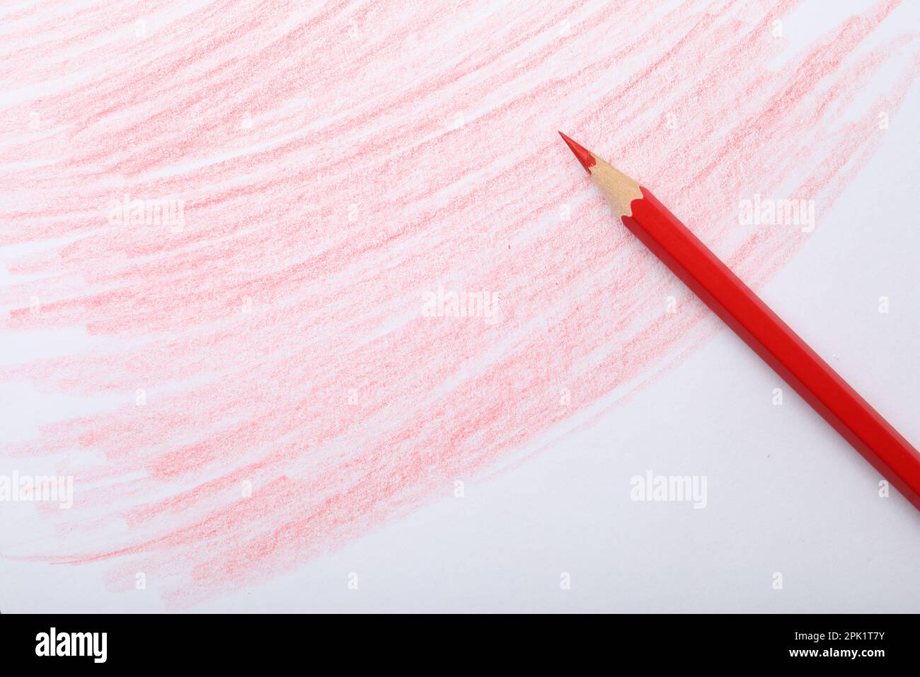 Red pencil on sheet of paper with drawing, top view Stock Photo - Alamy