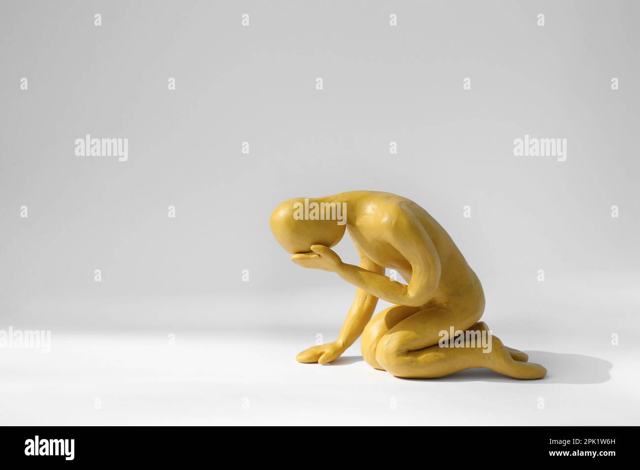 Plasticine figure of crying human on white background. Space for text ...