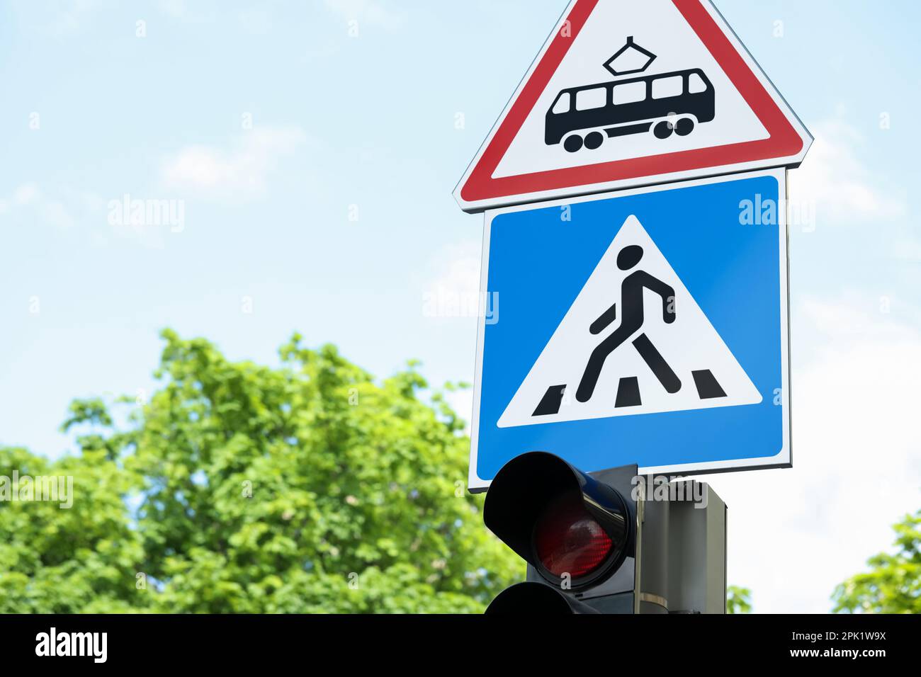 Post with Tram and Pedestrian crossing road signs over traffic lights ...