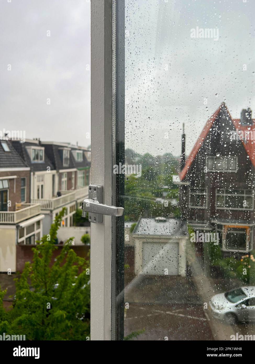 Beautiful cityscape with buildings on rainy day, view through open ...