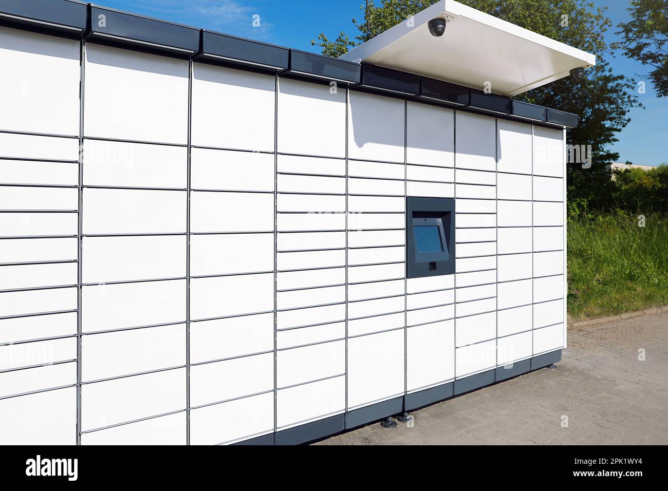 Modern parcel locker with many postal boxes outdoors Stock Photo - Alamy