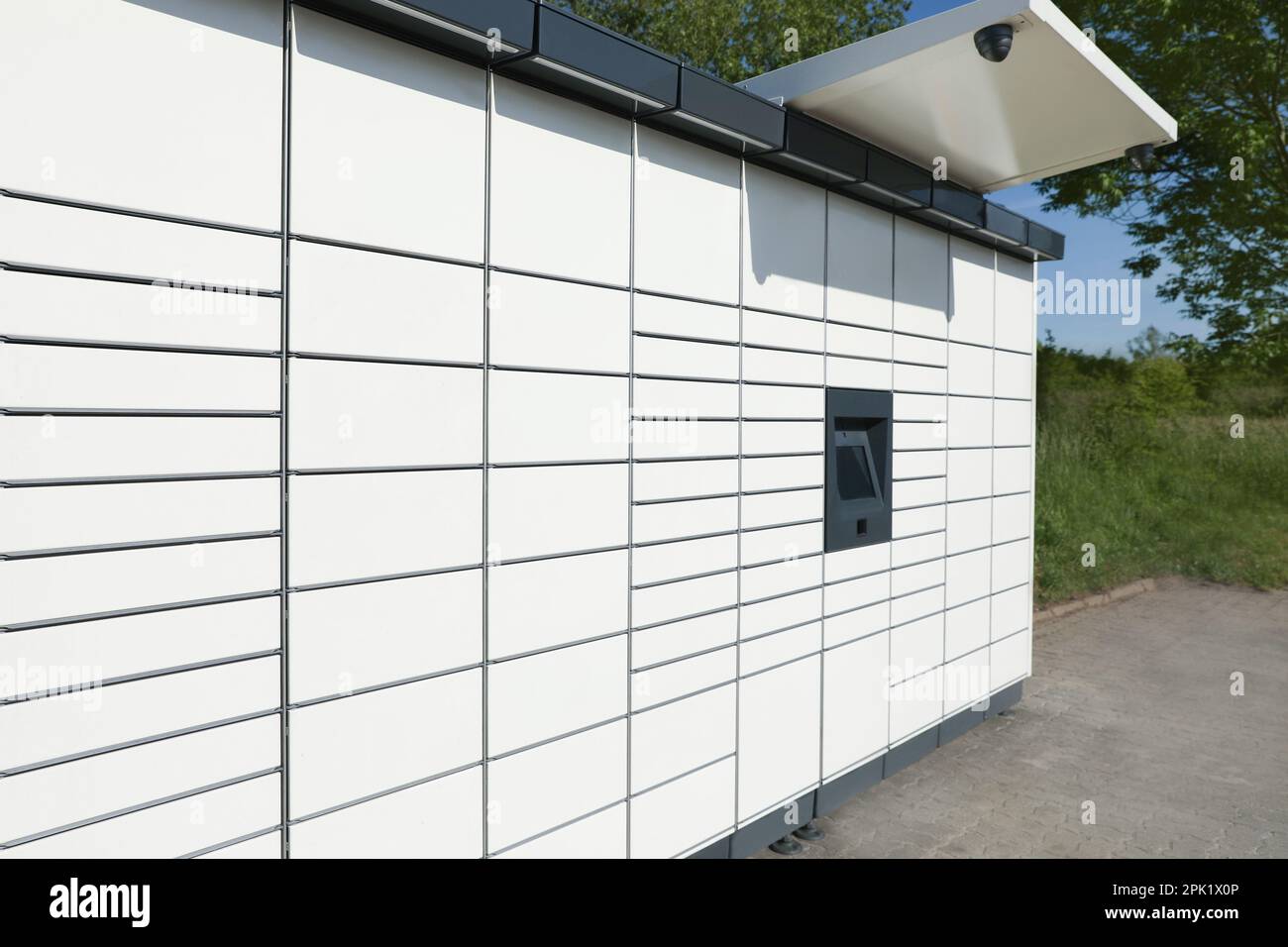 Modern parcel locker with many postal boxes outdoors Stock Photo - Alamy