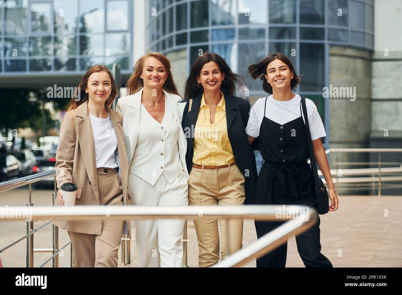 Standing together. Women in formal wear is outdoors in the city Stock ...