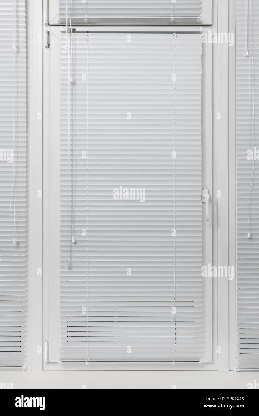 Window with closed white horizontal blinds indoors Stock Photo - Alamy