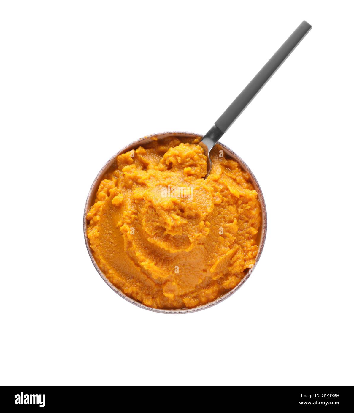 Delicious vegetable puree and spoon in bowl isolated on white, top view ...