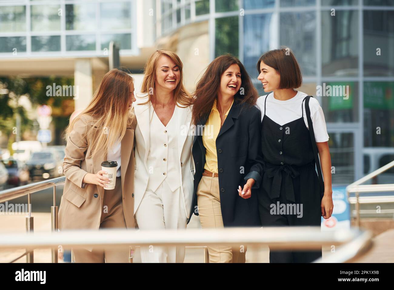 Women in formal wear is outdoors in the city together Stock Photo - Alamy