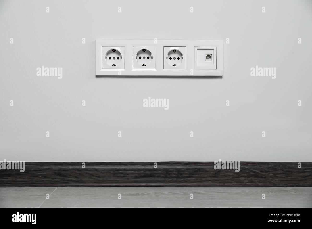 Power sockets on white wall indoors. Electrical supply Stock Photo - Alamy