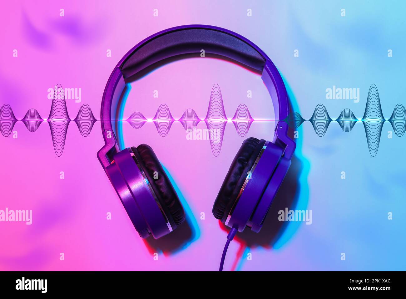 Modern headphones with illustration of dynamic sound waves on color ...