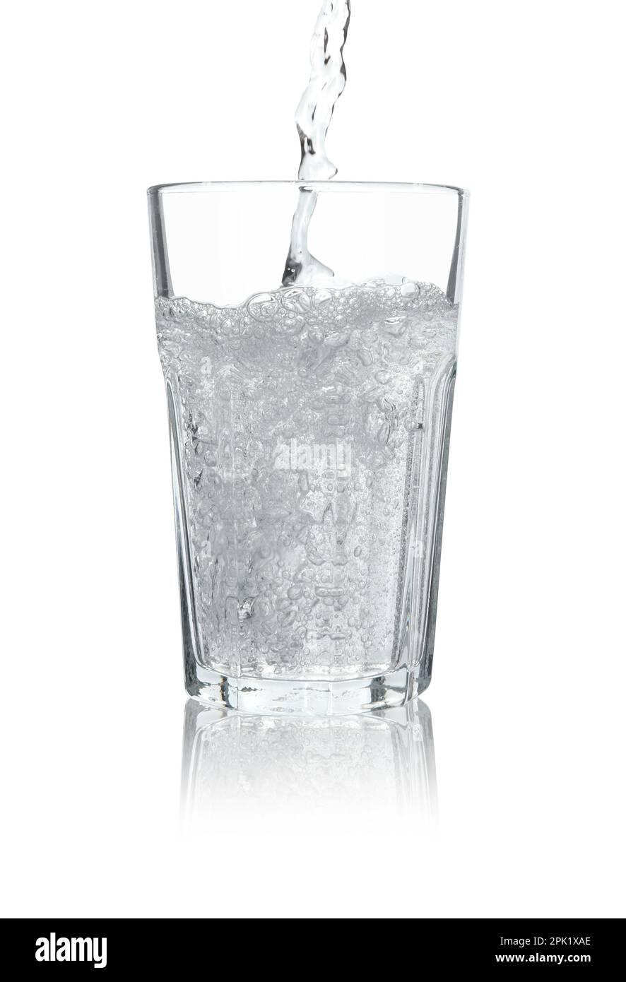 Pouring soda water into glass on white background Stock Photo - Alamy