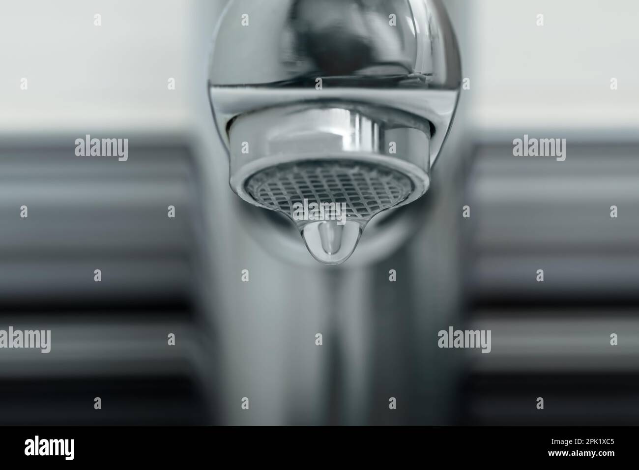 Water drop falling down from tap on blurred background, closeup Stock ...