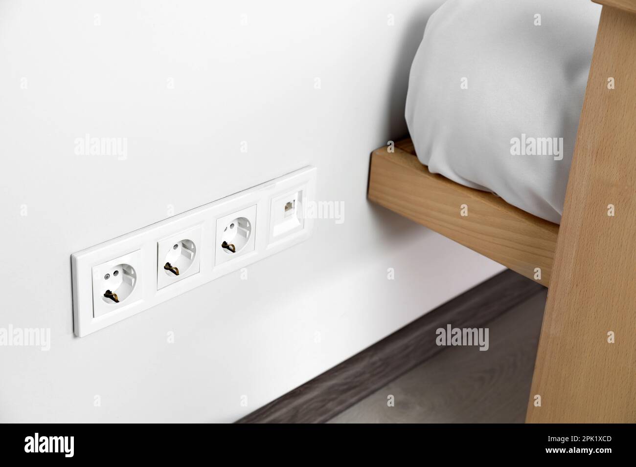 Power sockets on white wall indoors. Electrical supply Stock Photo - Alamy