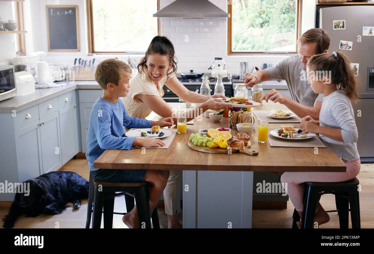 Family breakfasts are their tradition. two affectionate young parents ...