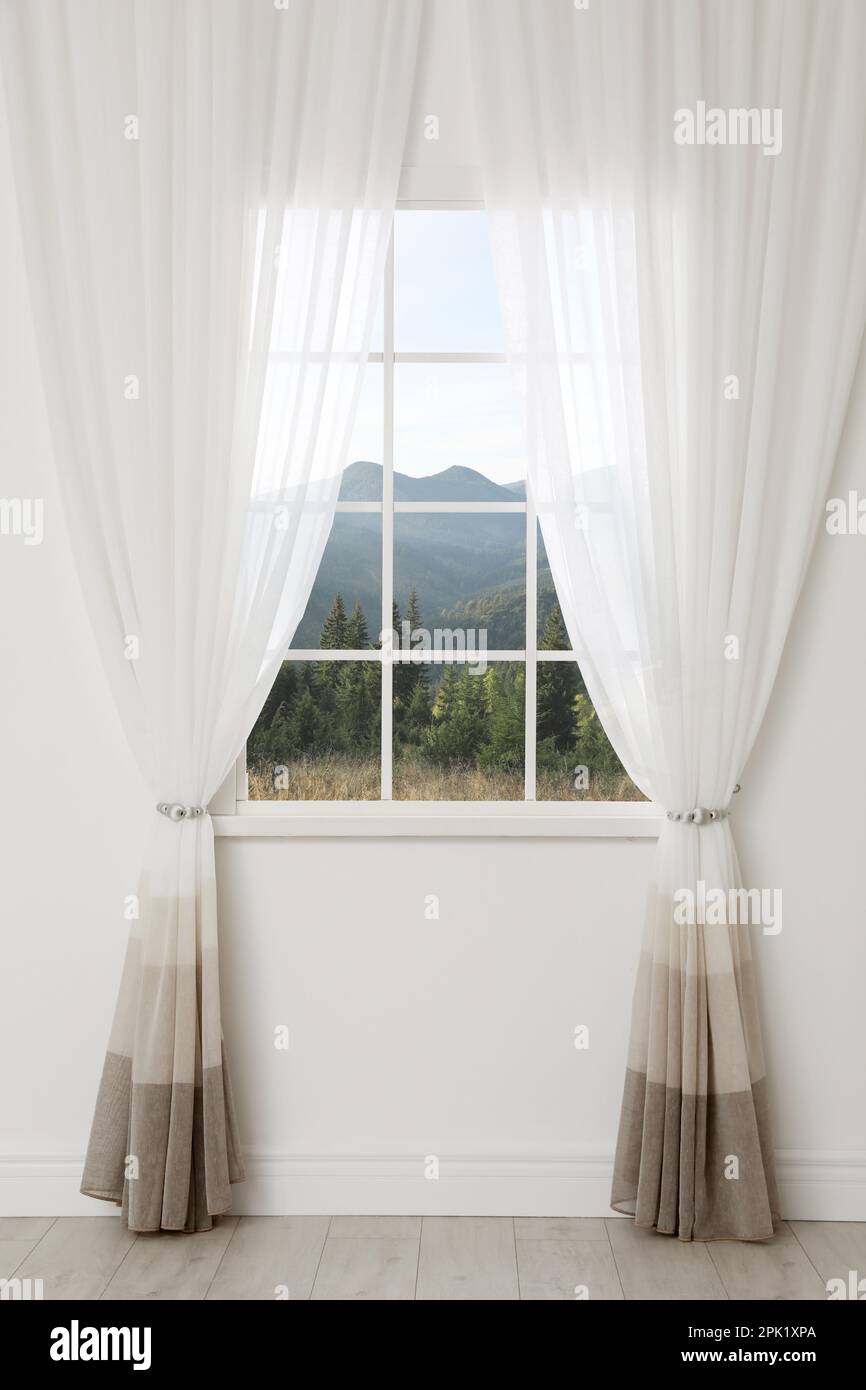 Beautiful view of mountain landscape through window with curtains Stock ...