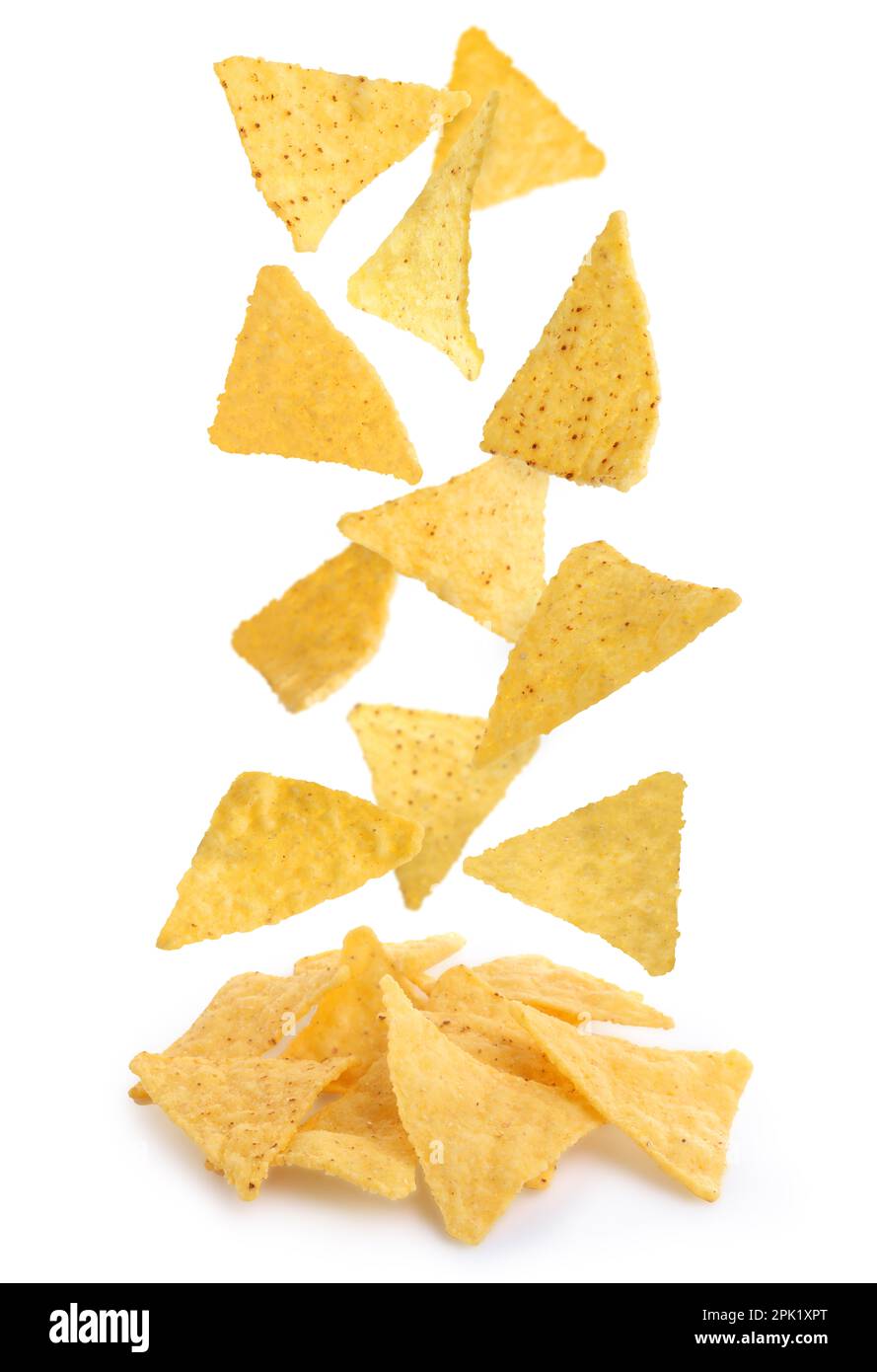 Tasty tortilla chips (nachos) falling into pile on white background ...