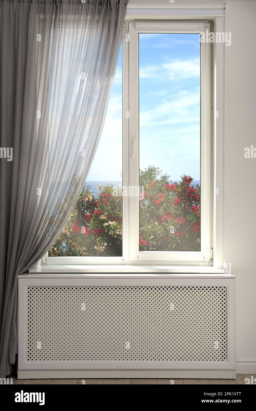 Beautiful view of bushes and sea through window Stock Photo - Alamy
