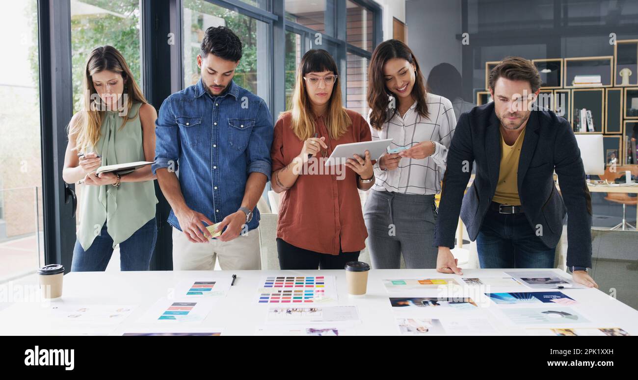 Putting new plans into action. a group of designers brainstorming ...