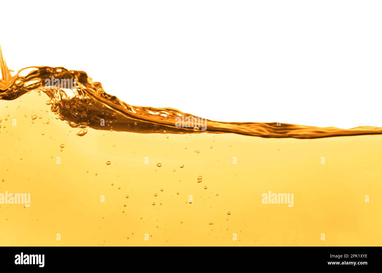 Golden oily liquid splash on white background Stock Photo - Alamy