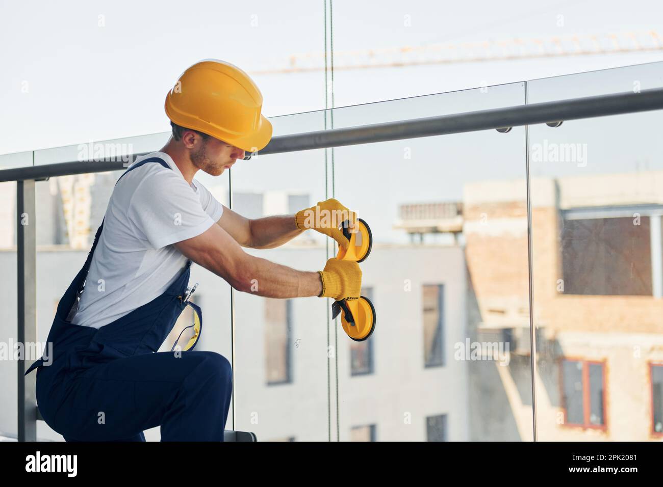 Installation of windows. Young man working in uniform at construction ...