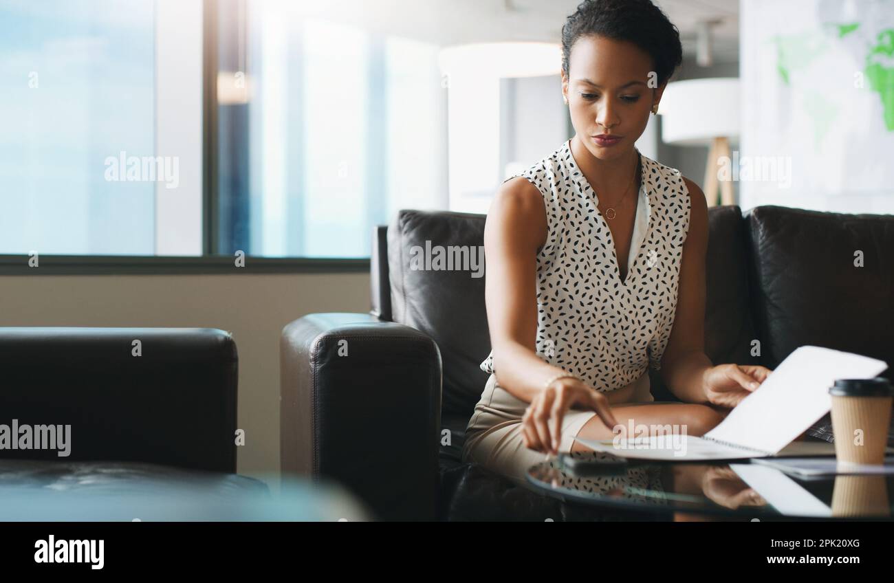 Working through some paperwork during my break. a businesswoman working ...